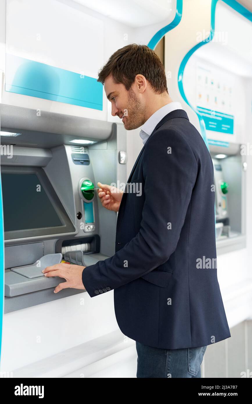 Young man cash machine hi-res stock photography and images - Alamy