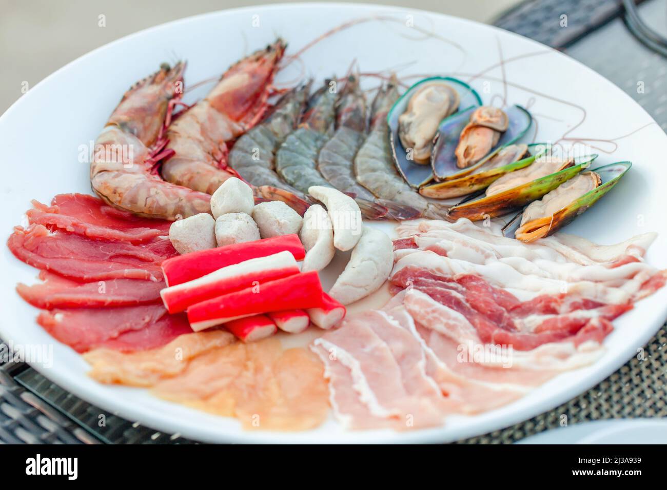 Assortment of fresh seafood, meat for cooking in grill or hot pot ...