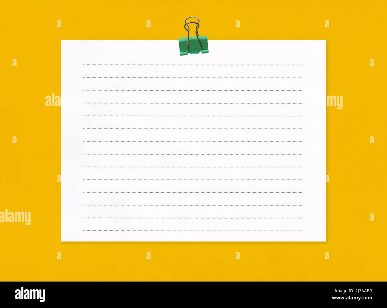 Empty note paper with clip on yellow art paper background and have copy ...