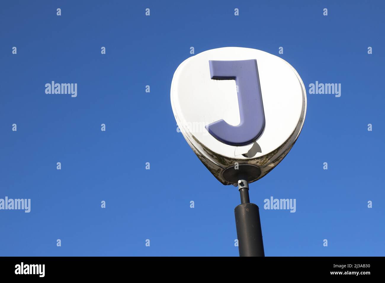 Low angle view of a letter J sign in use at the commuter train railroad ...