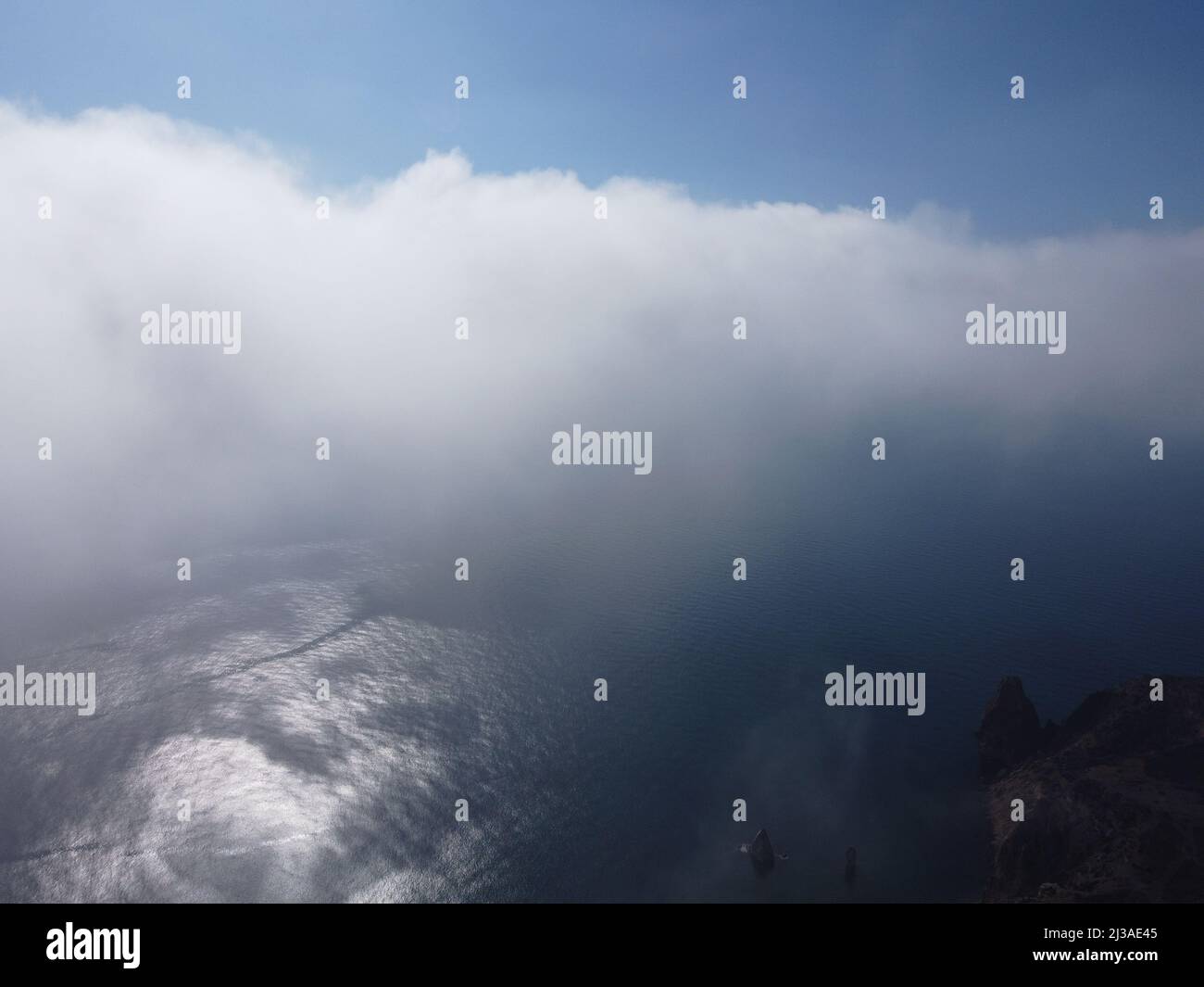 Aerial view. The drone flies over foggy and fluffy clouds. Blue sky sun ...