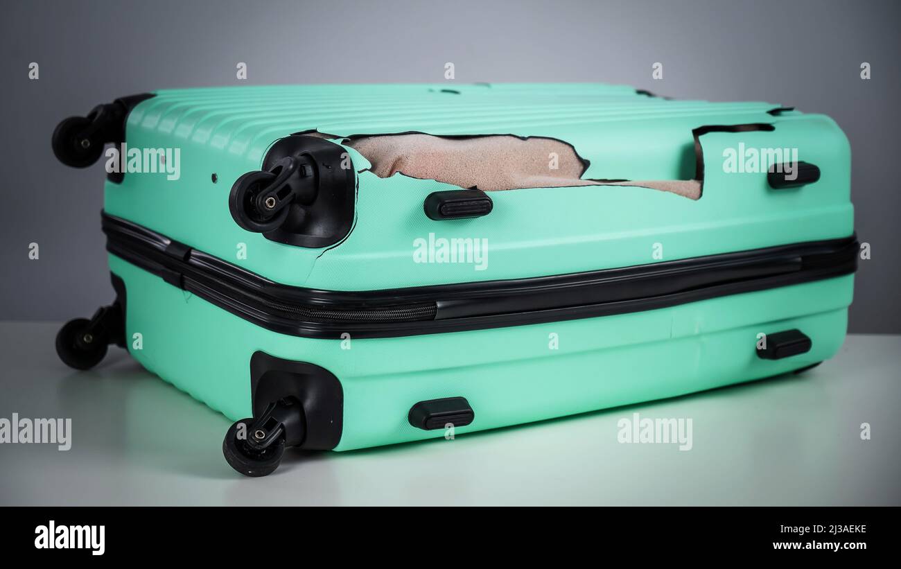 Mint damaged suitcase on a white background Stock Photo - Alamy