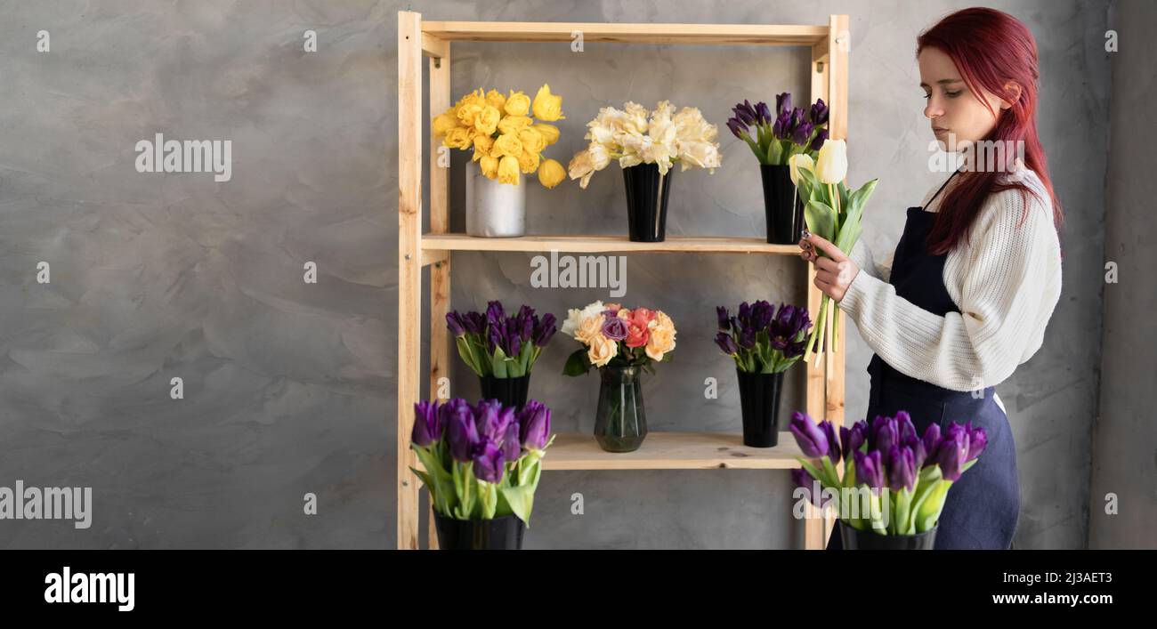 Small business. woman florist focusing in flower shop. Floral design ...