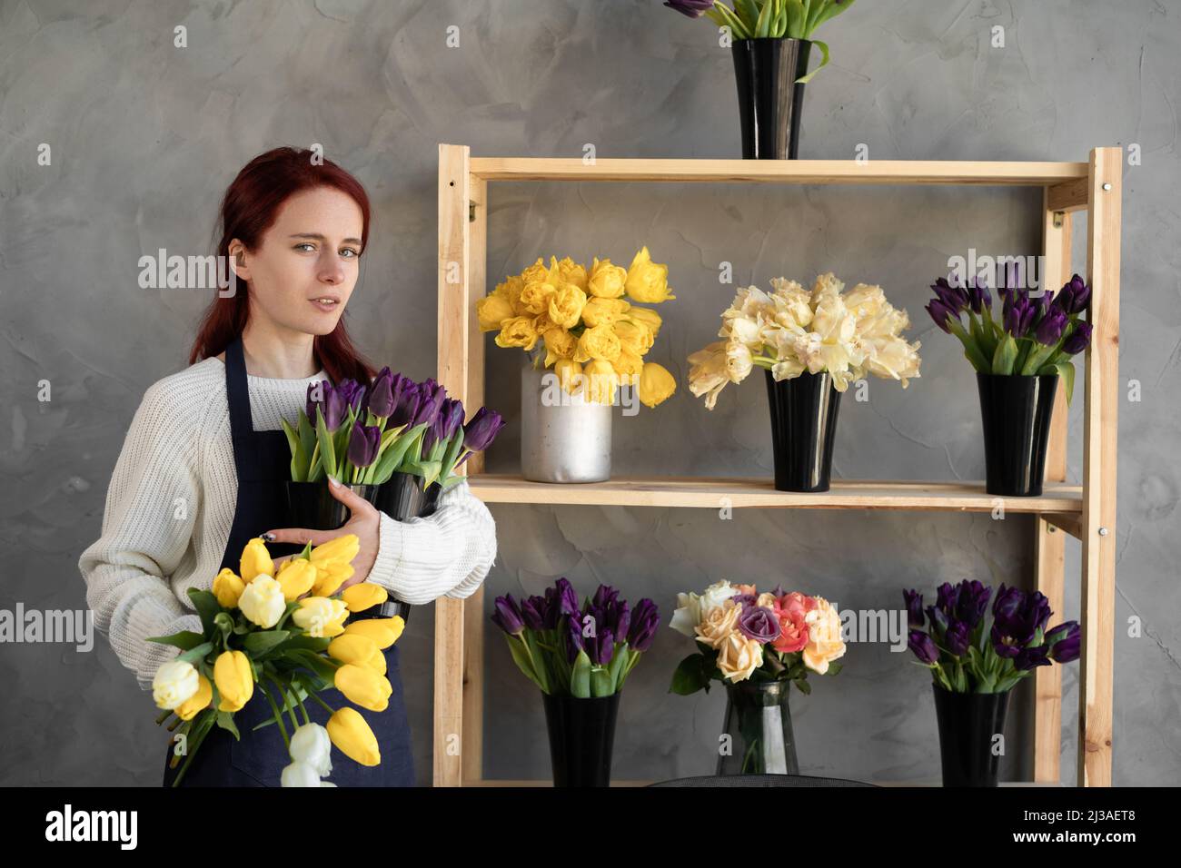 portrait of a young professional decorator florist using beautiful ...