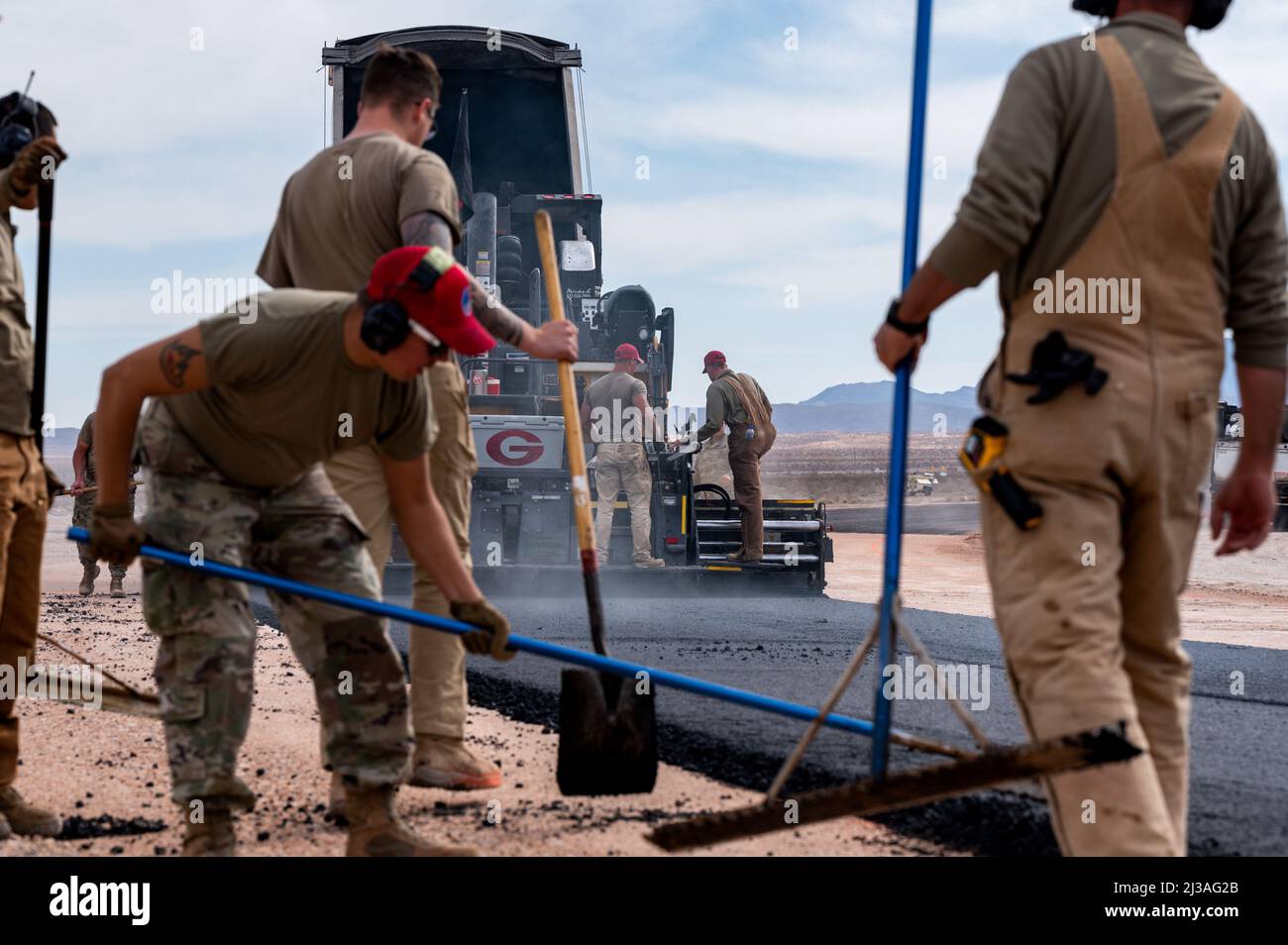 Airmen from the 820th RED HORSE Squadron fix the edges of the newly ...
