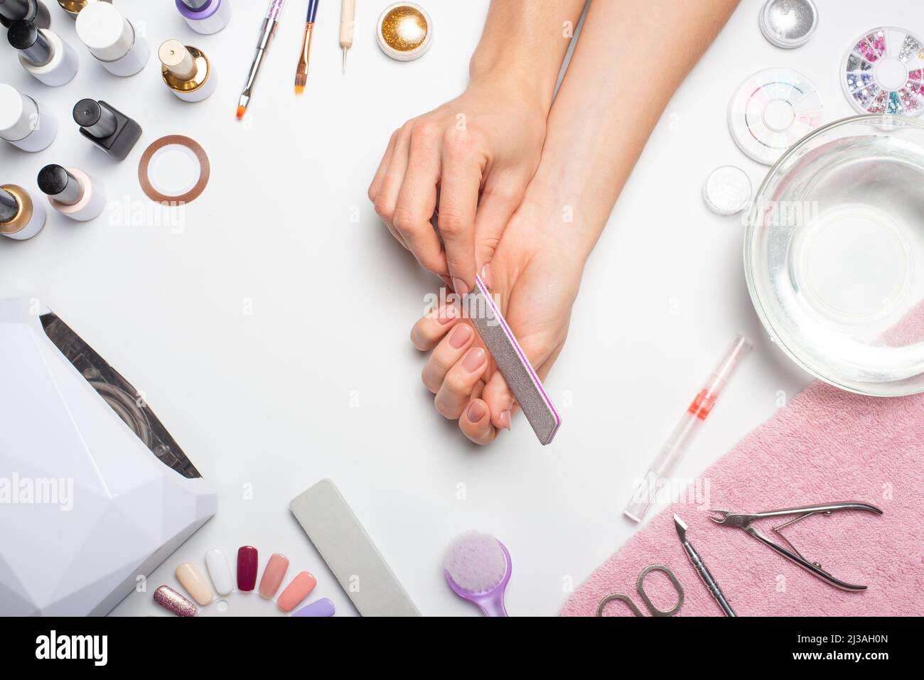 Manicure - the girl herself does, watching the nails with the help of a ...