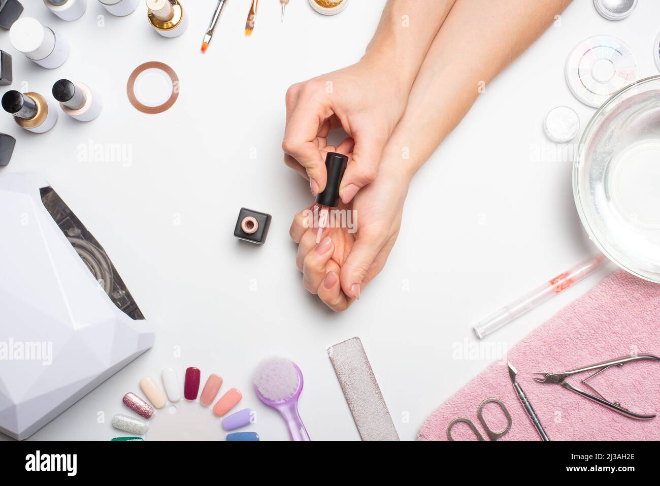 Manicure - the girl herself does, watching the nails with the help of a ...