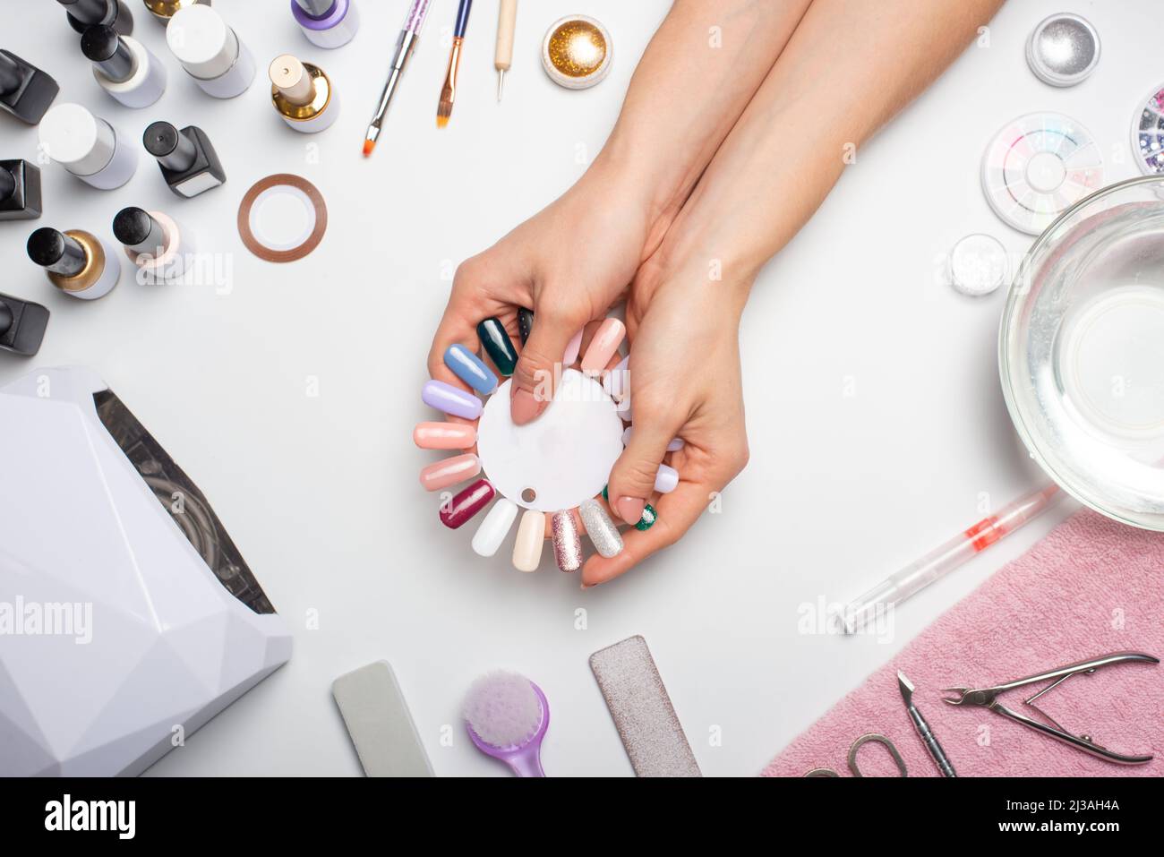 Manicure - the girl herself does, watching the nails with the help of a ...
