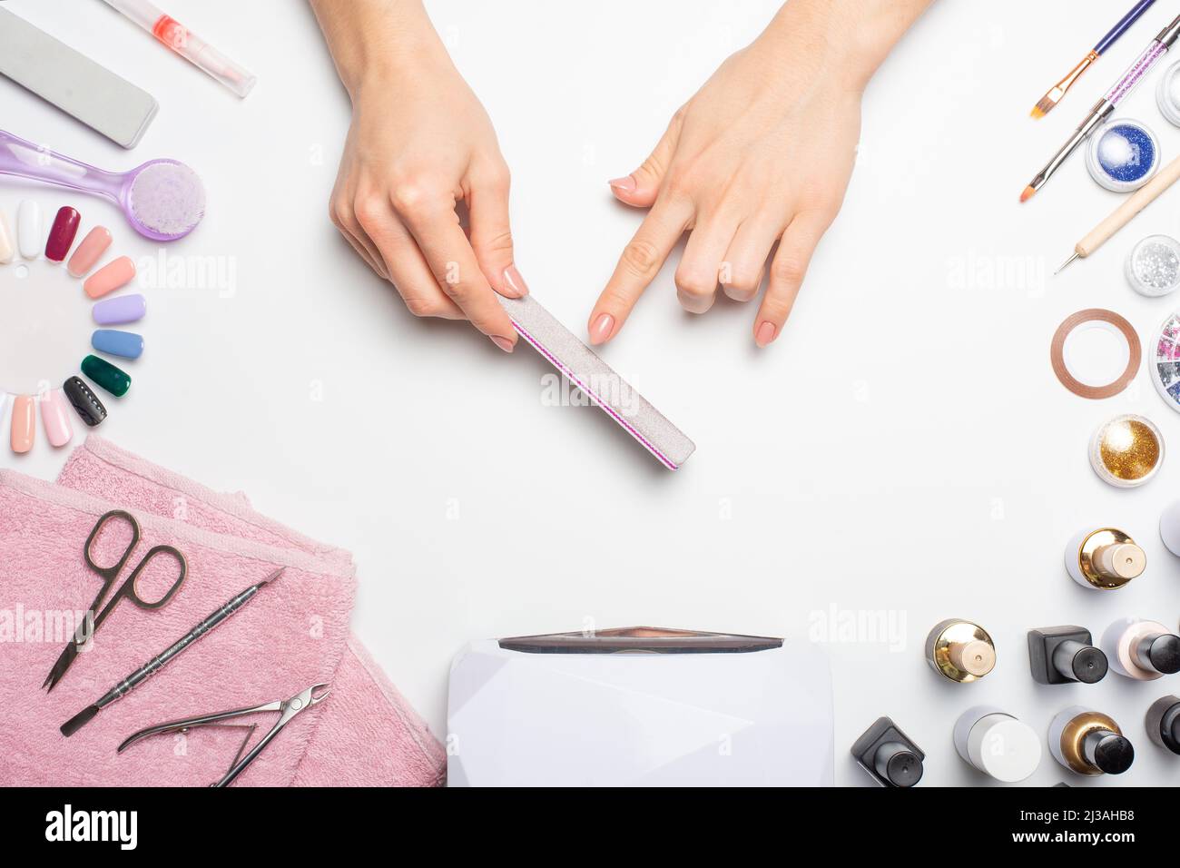 Manicure - the girl herself does, watching the nails with the help of a ...