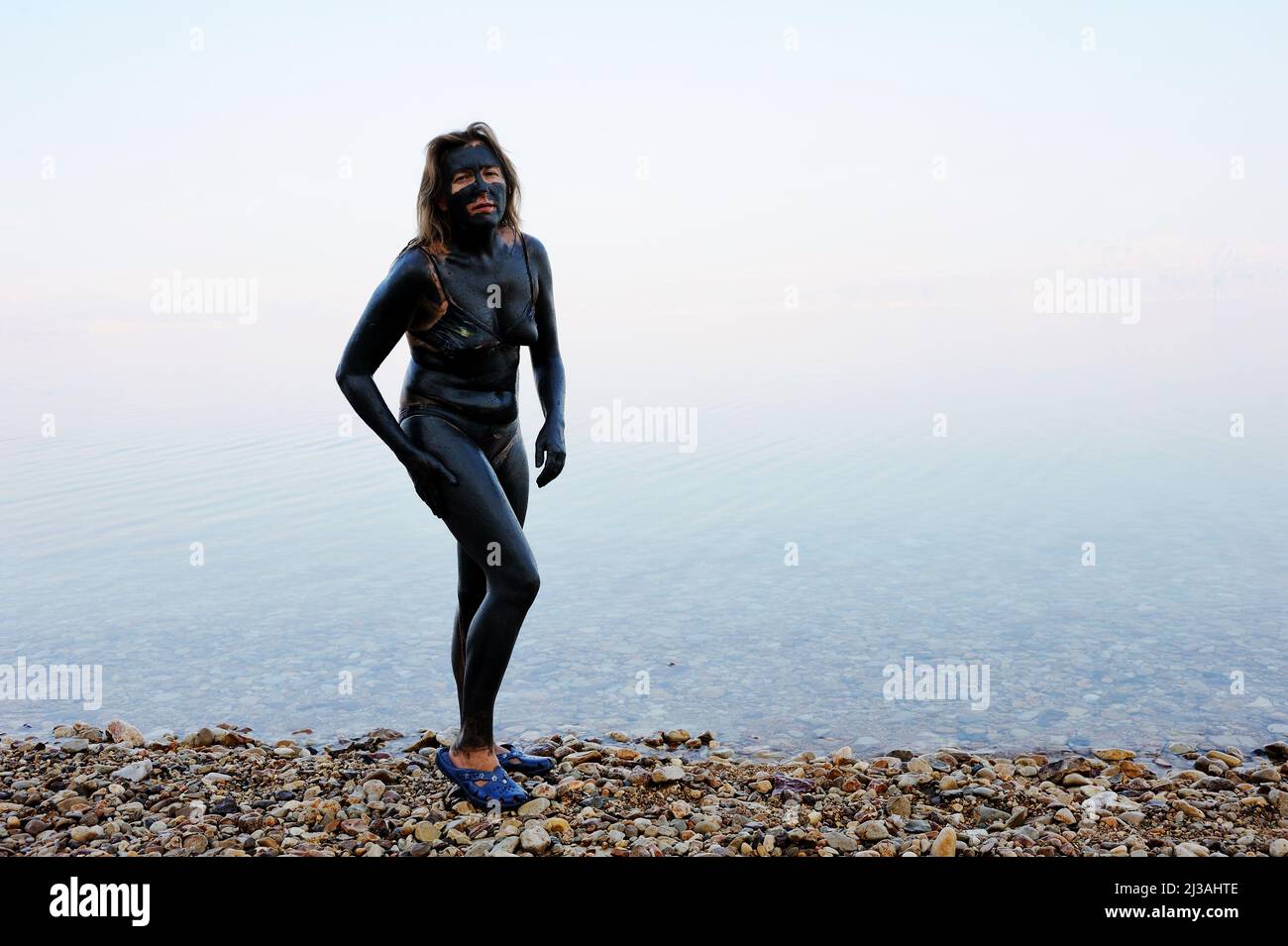 Woman daubed themselves therapeutic mud on the shore of the Dead Sea ...
