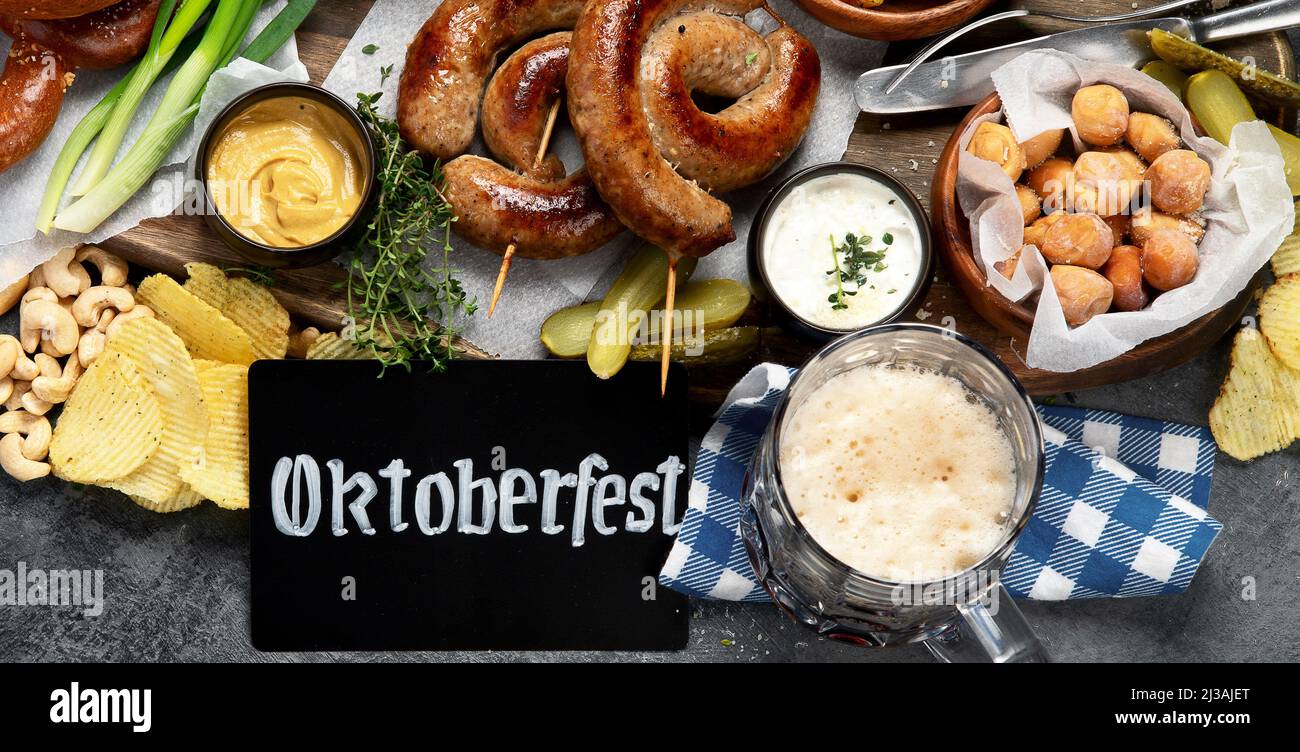Octoberfest dinner table concept with grilled pork sausages, pretzel ...