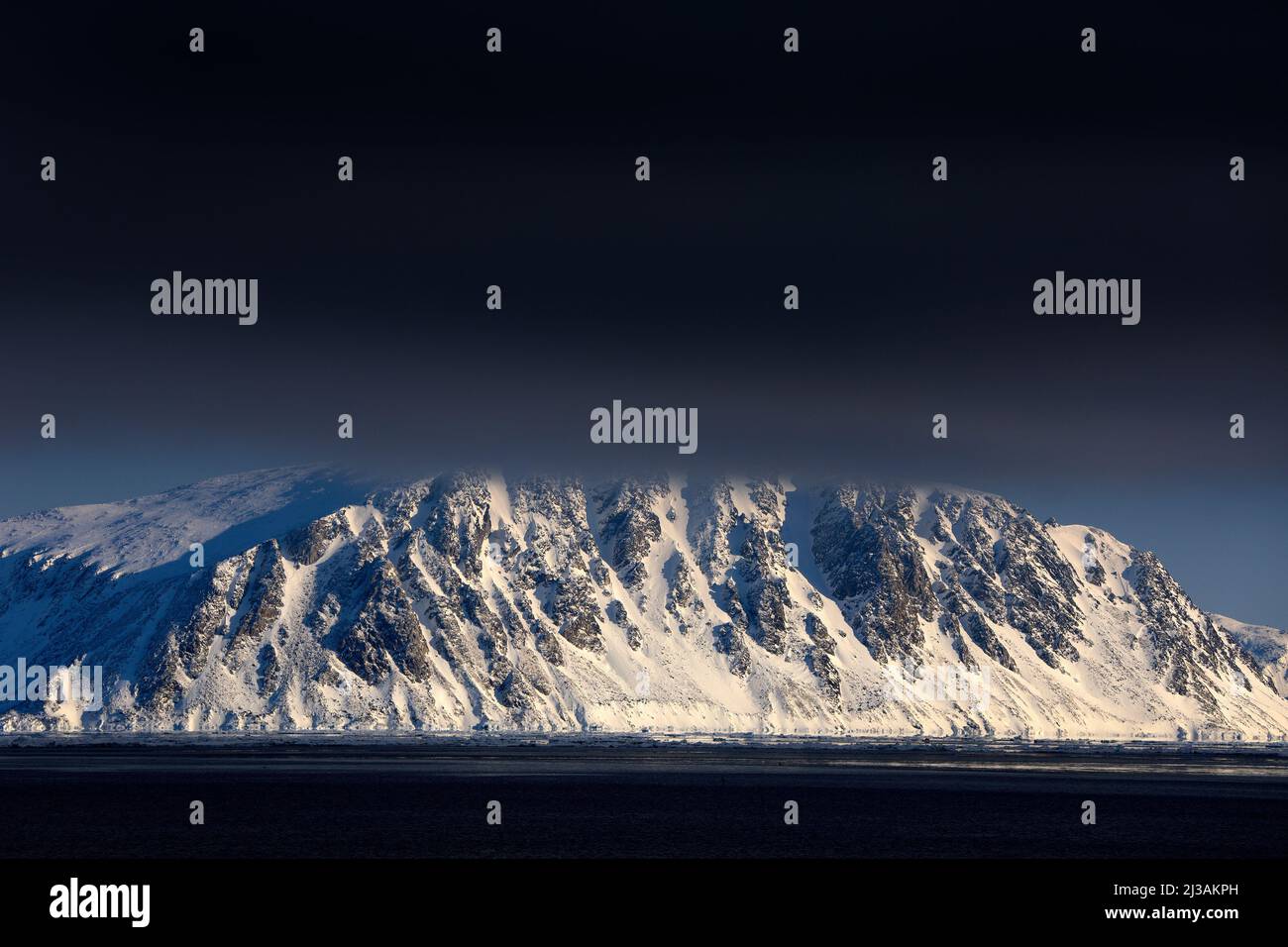 White snowy mountain, blue glacier Svalbard, Norway. Ice in ocean ...