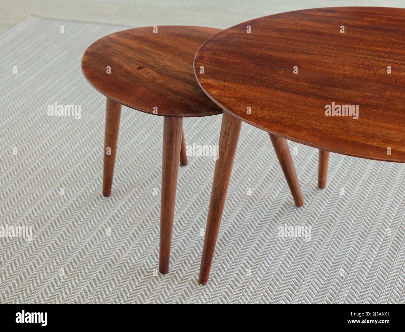Double wooden table on carpet in interior of a living room or hotel ...
