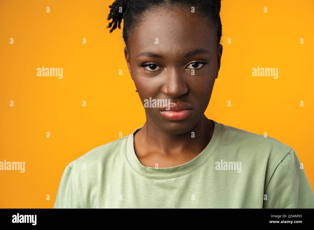 Beautiful african woman having skeptical and dissatisfied look against ...