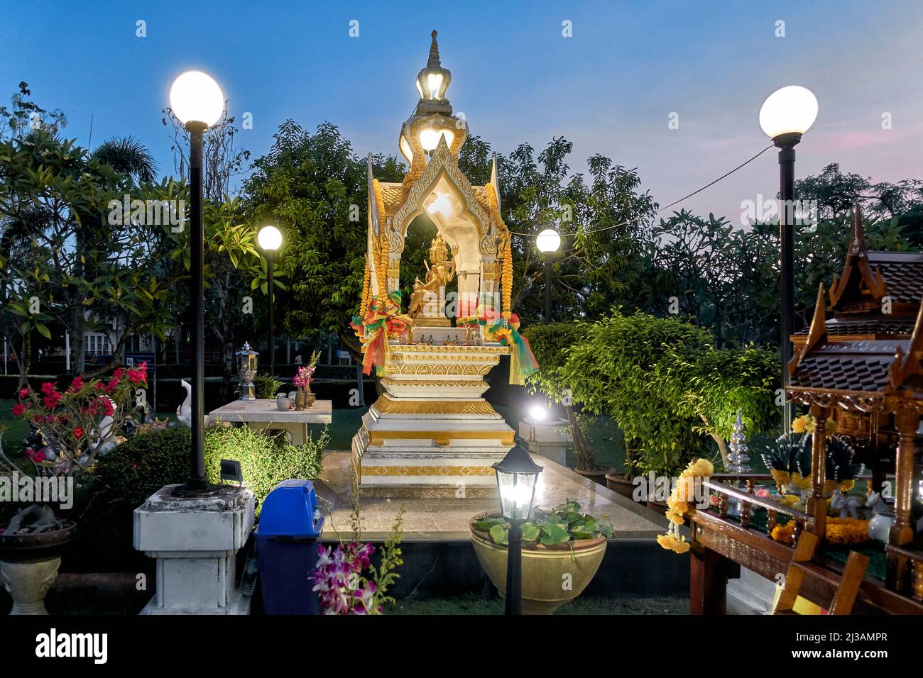Spirit house Thailand. Phra Phrom Shrine and wood spirit house lit at ...