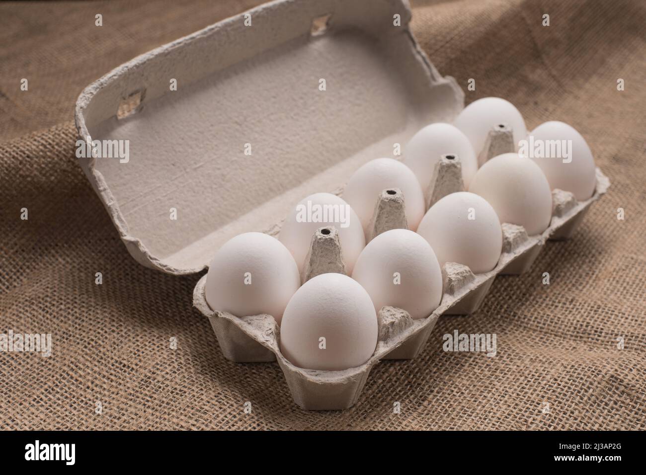 eggs in box on fabric texture Stock Photo - Alamy