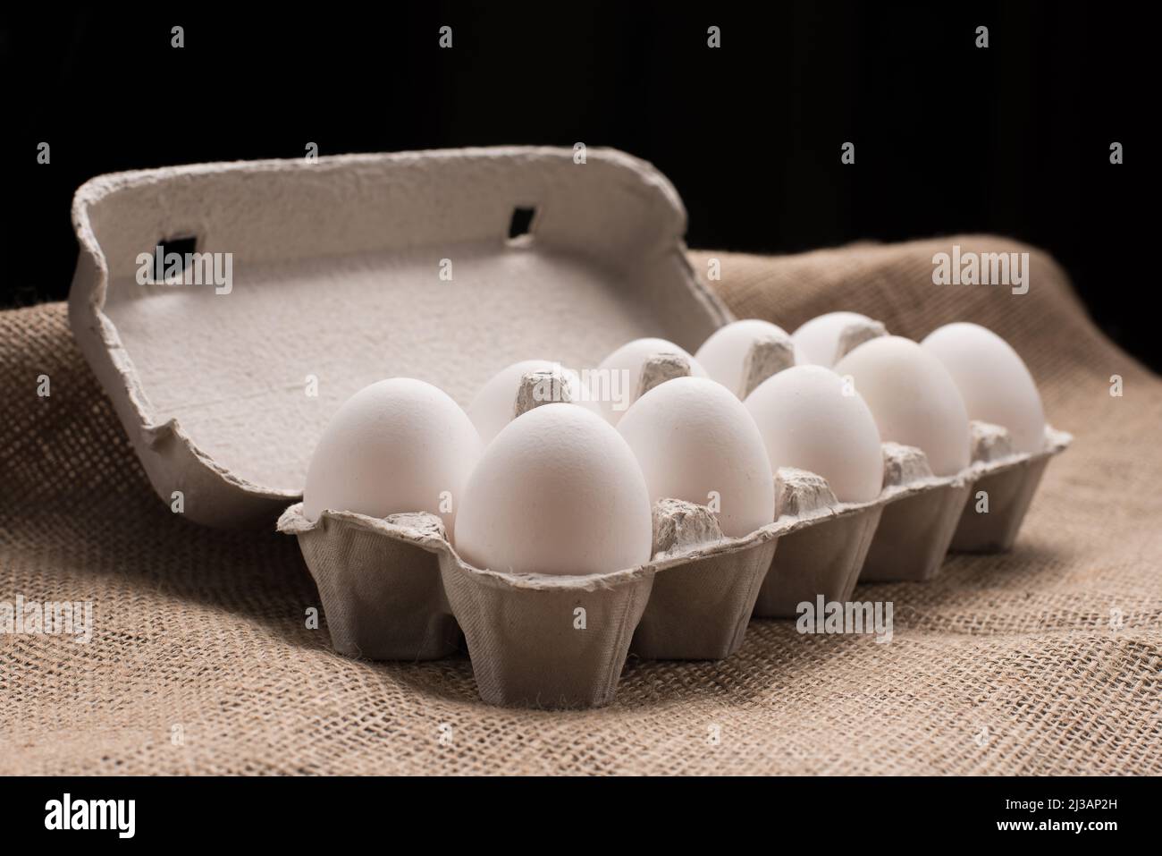 eggs in box on fabric texture Stock Photo - Alamy