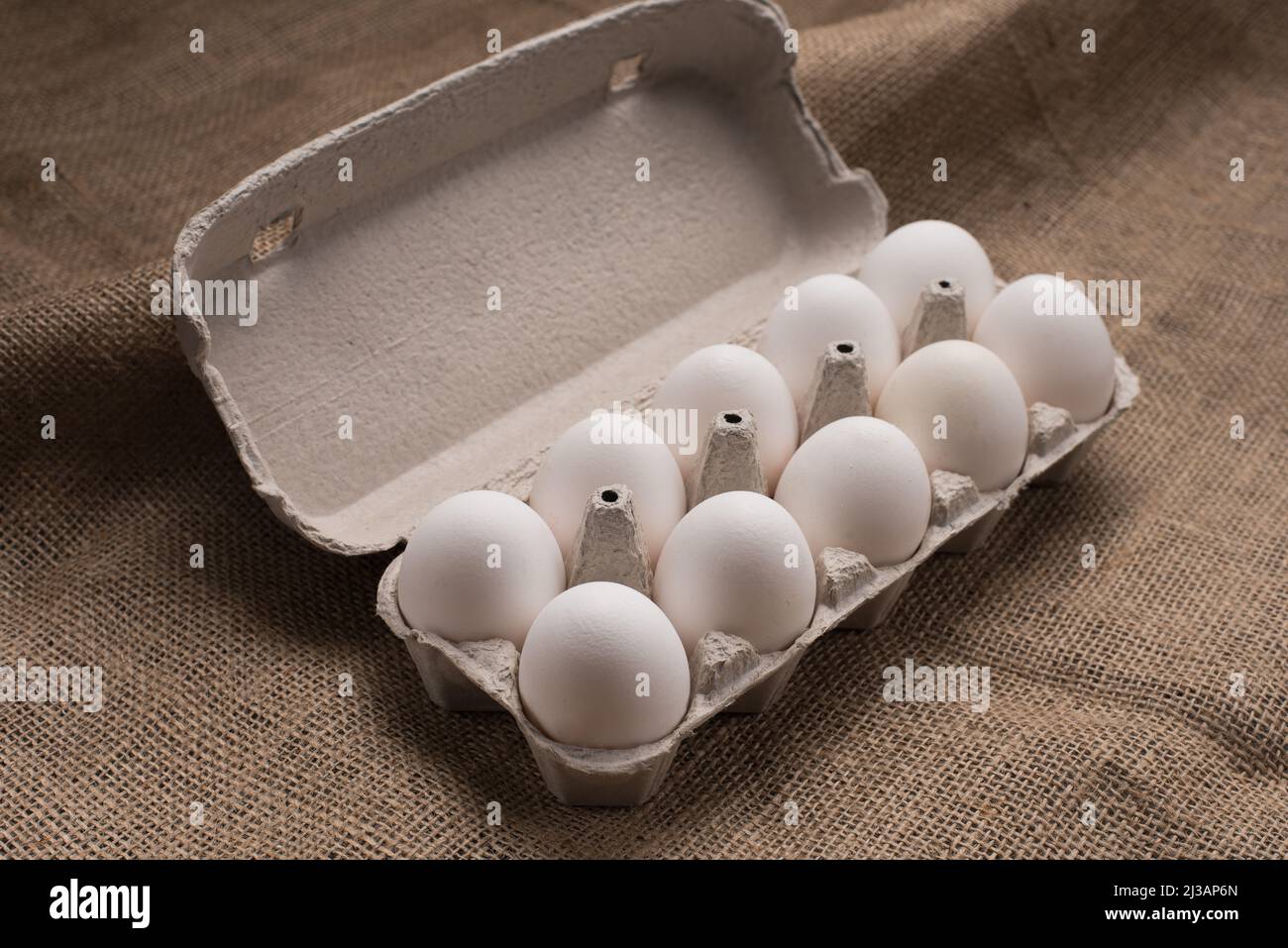 eggs in box on fabric texture Stock Photo - Alamy
