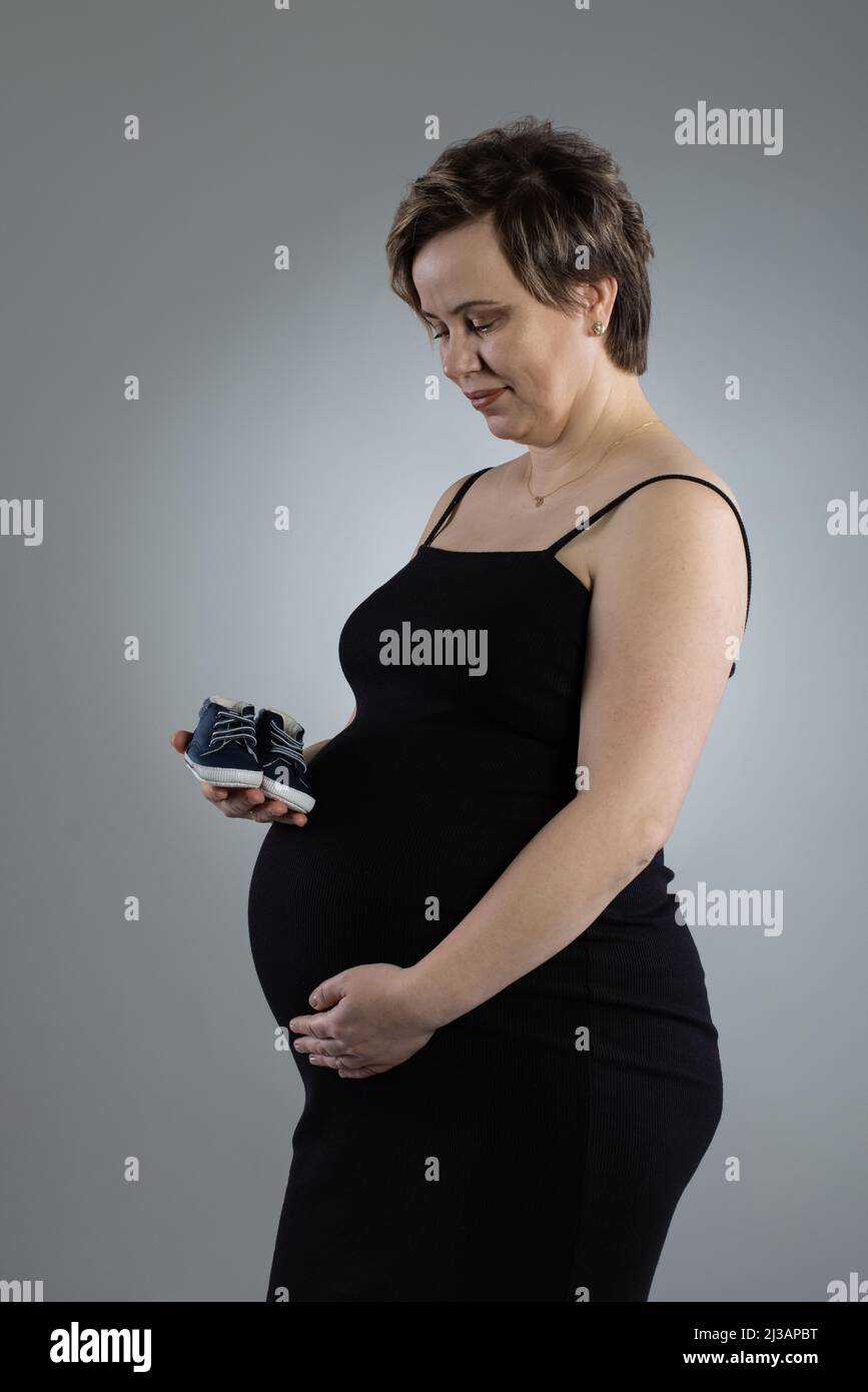 Portrait of pregnant woman on her third trimester, two weeks before ...