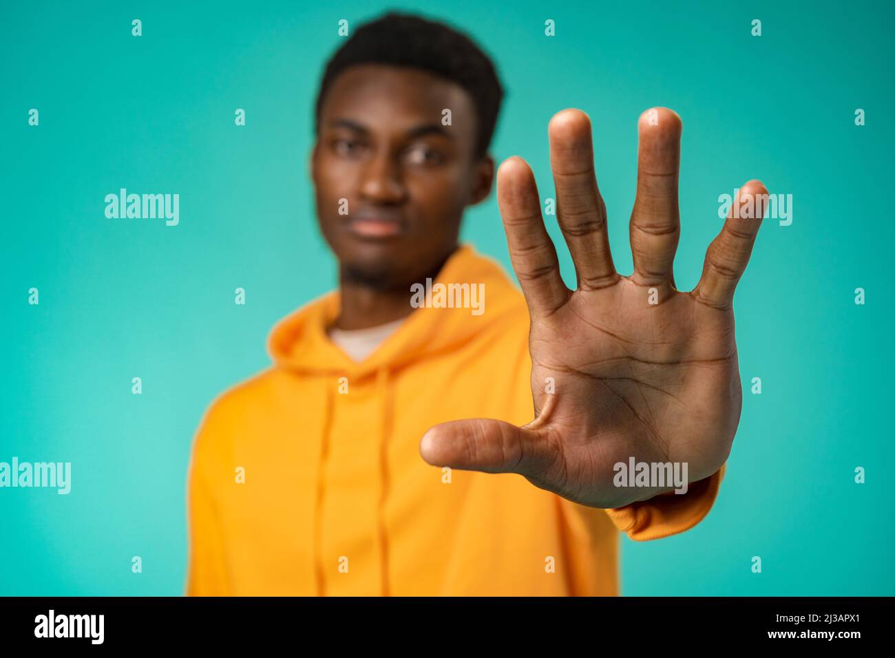 Young african american man over studio background doing stop sing with ...