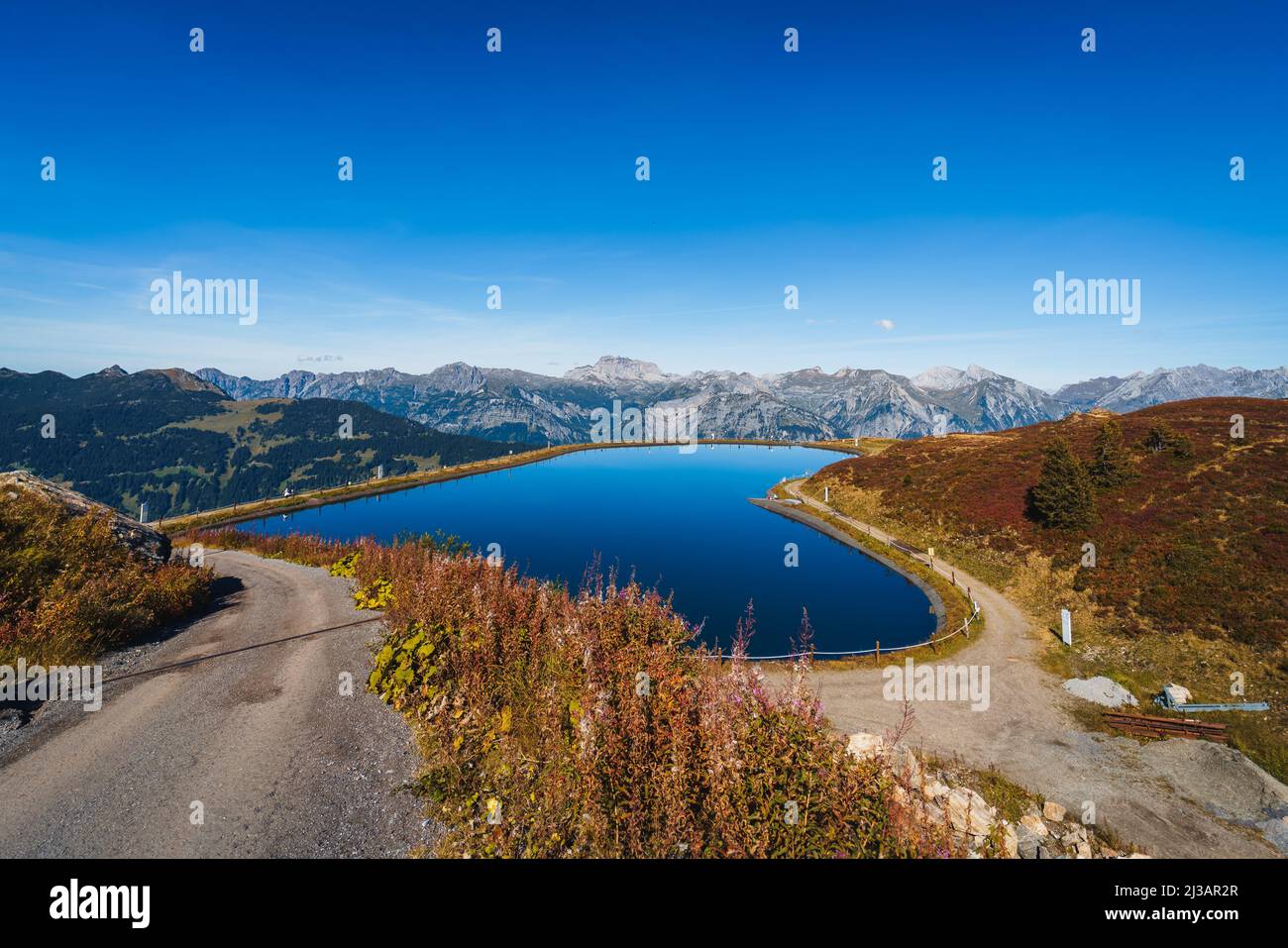 An aerial landscape view of the canyon Hochjoch mountain, a large lake ...