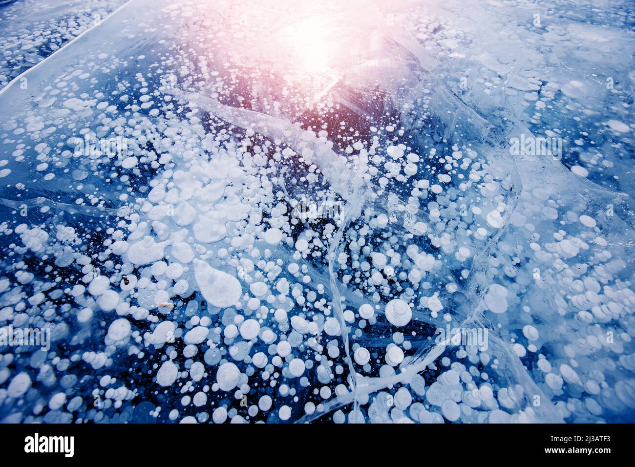 Gas methane bubbles frozen in winter ice of lake Baikal, abstract ...