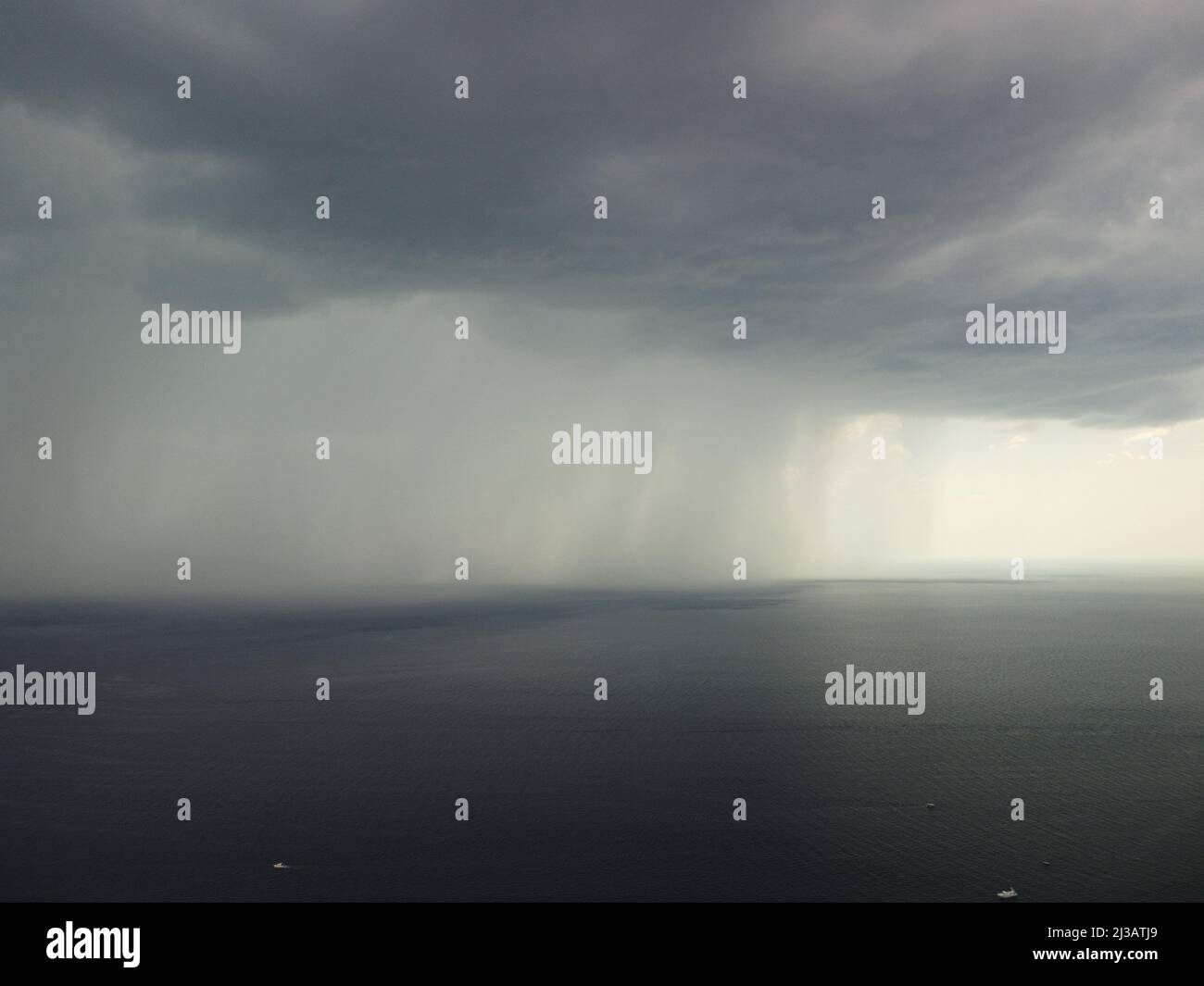 Aerial view footage of rain clouds over sea ocean Black clouds in bad ...