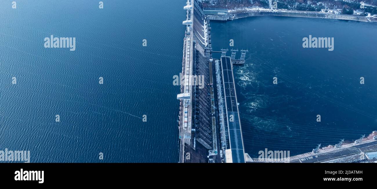 Aerial top view hydroelectric dam, water discharge through locks, blue ...