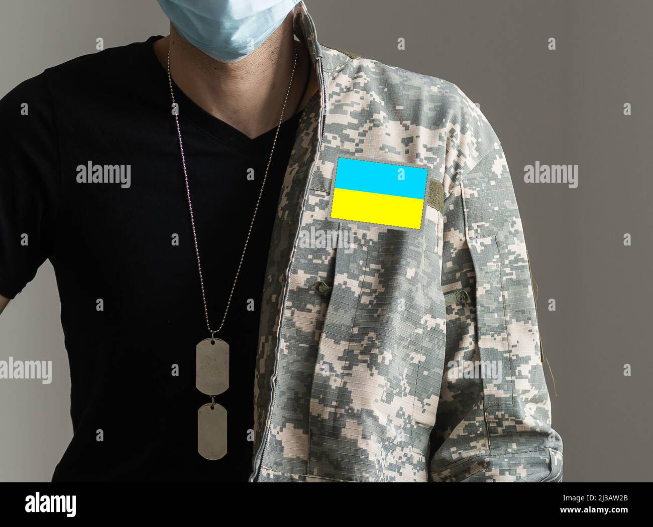 Ukrainian man warrior dressed in a military pixel uniform the yellow ...