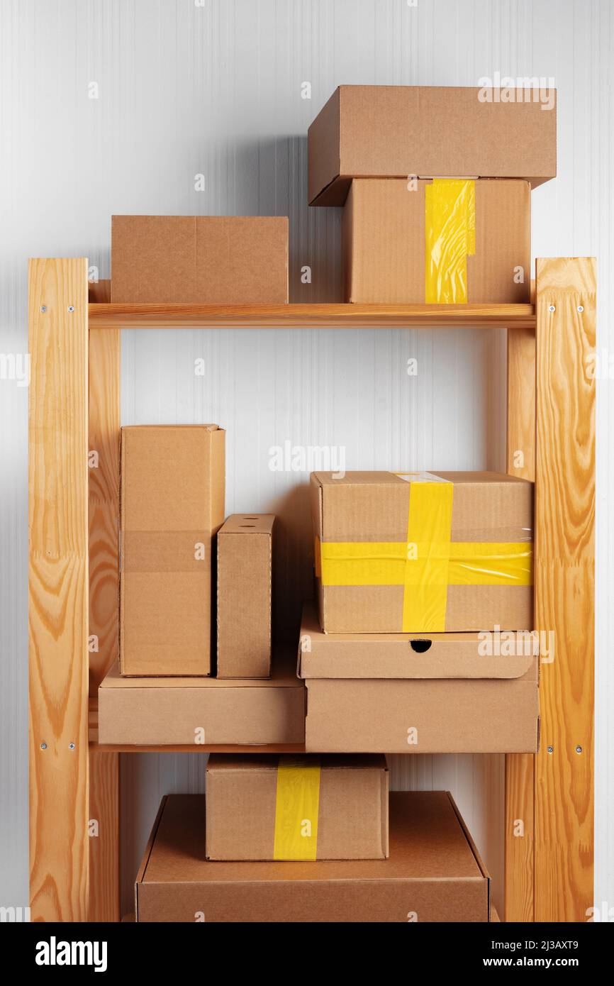 Stack of cardboard package boxes on wooden rack Stock Photo - Alamy