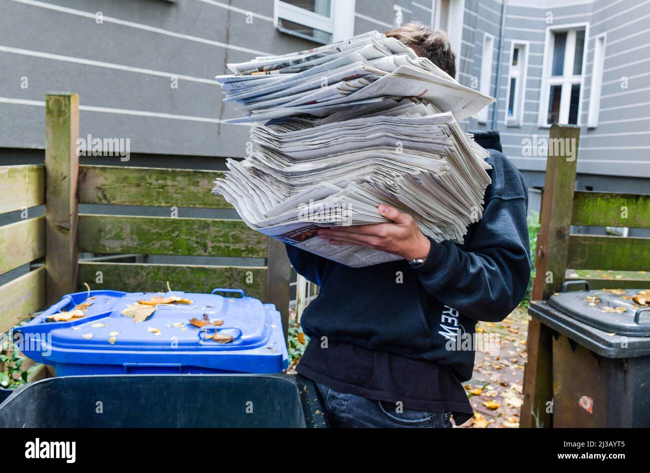 Newspapers, disposal, waste paper bin Stock Photo - Alamy