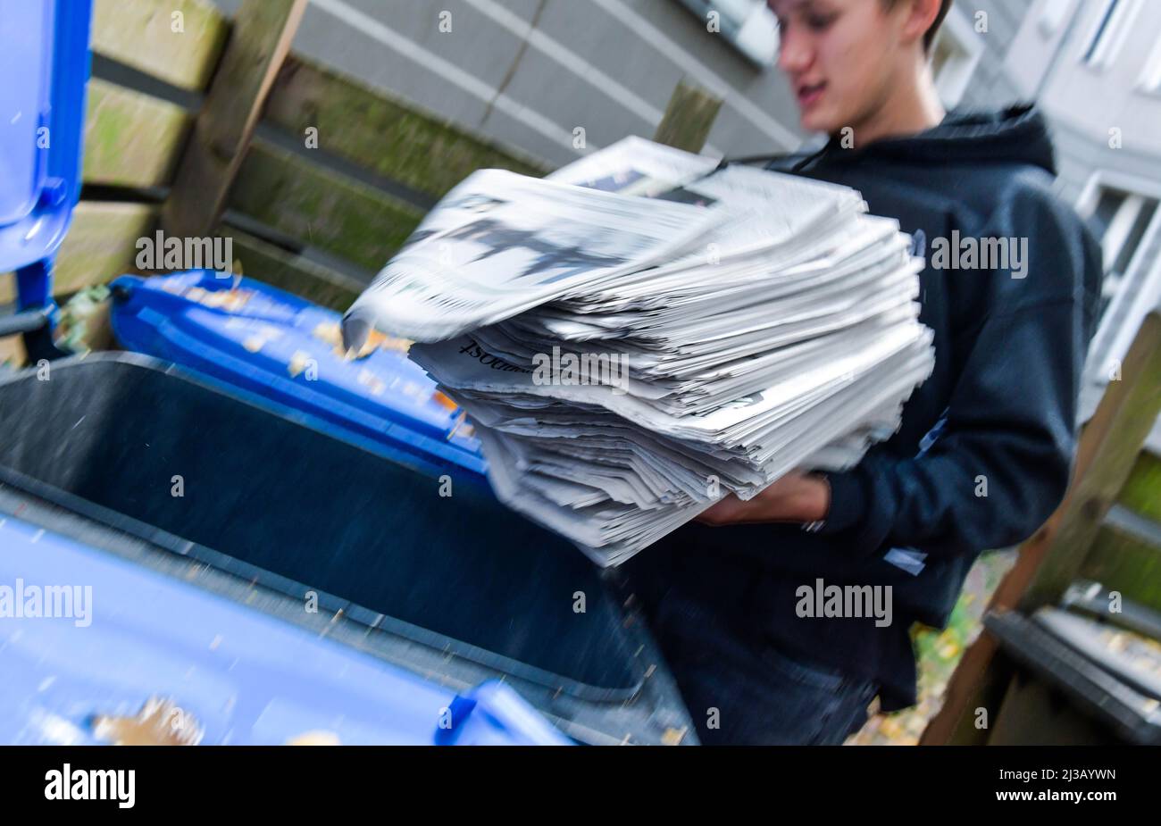 Newspapers, disposal, waste paper bin Stock Photo - Alamy