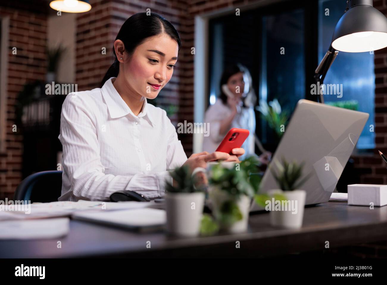 Businesswoman at work sending messages on social media platform using ...