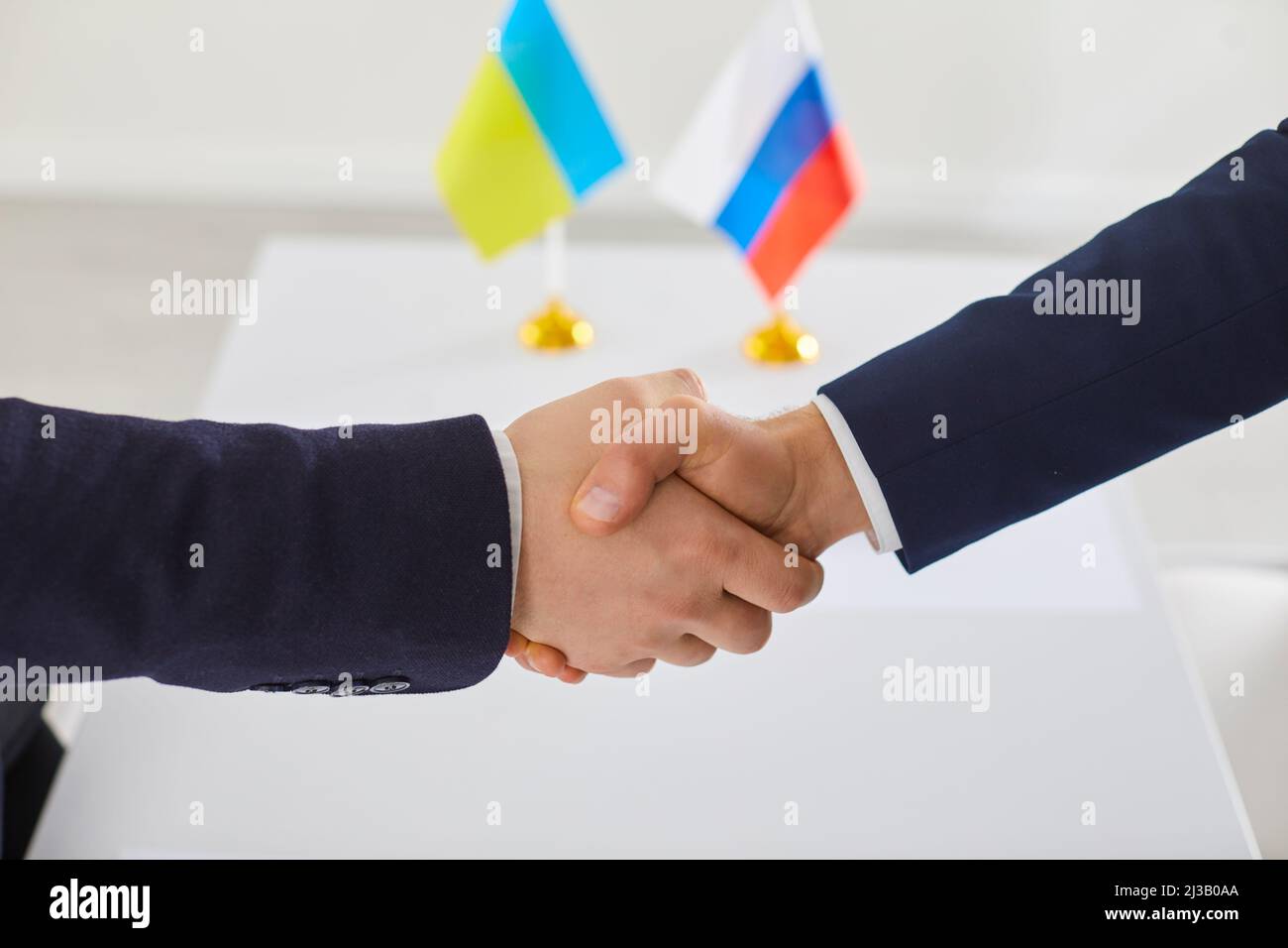 Political representatives of Ukrainian and Russian states shake hands ...