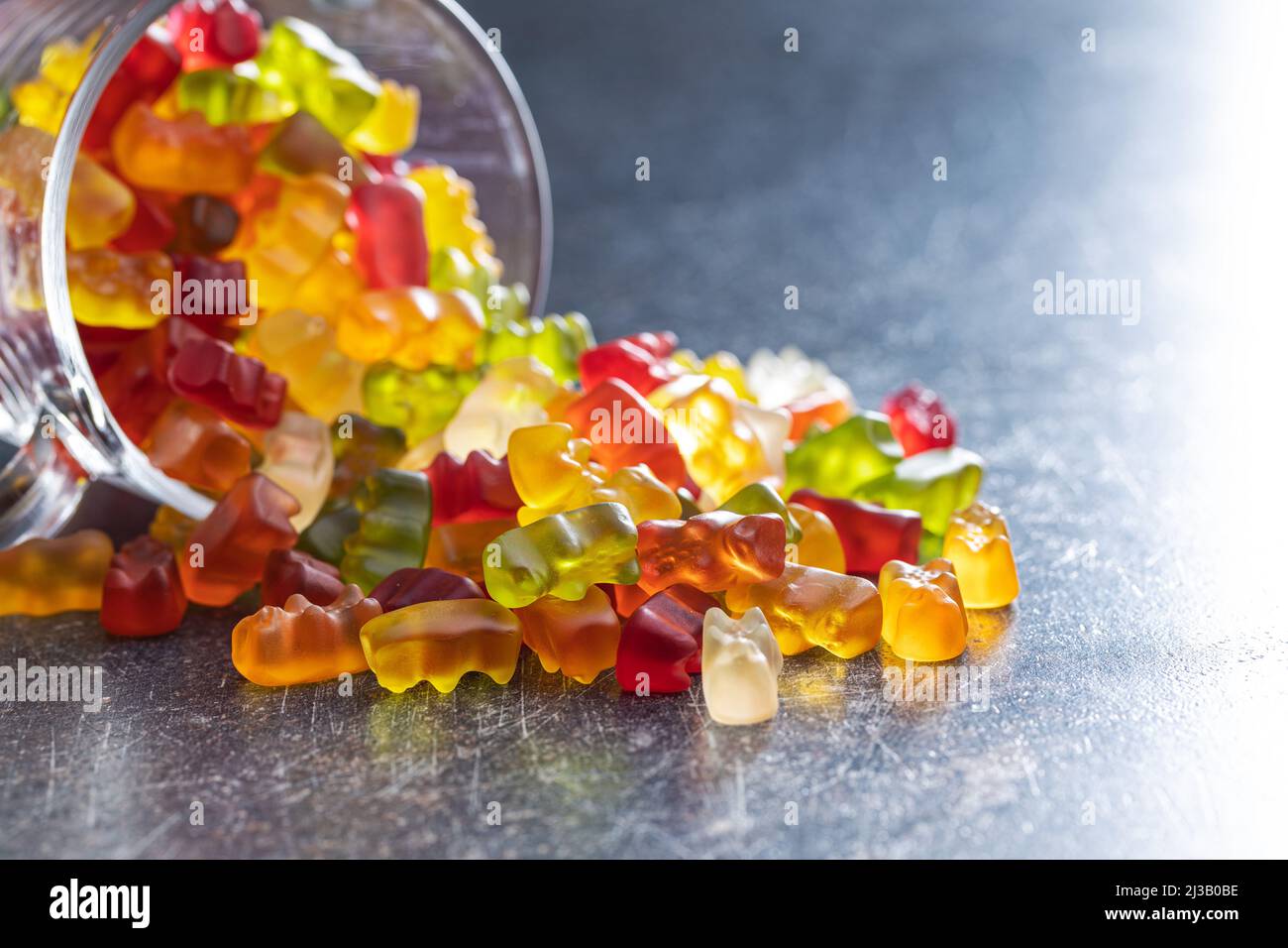 Jelly gummy bears candy. Colorful sweet confectionery on kitchen table ...