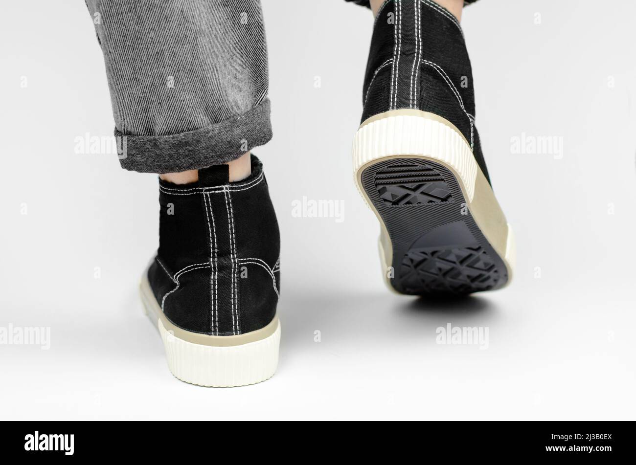 Rear view of female legs in sneakers, close-up Stock Photo - Alamy