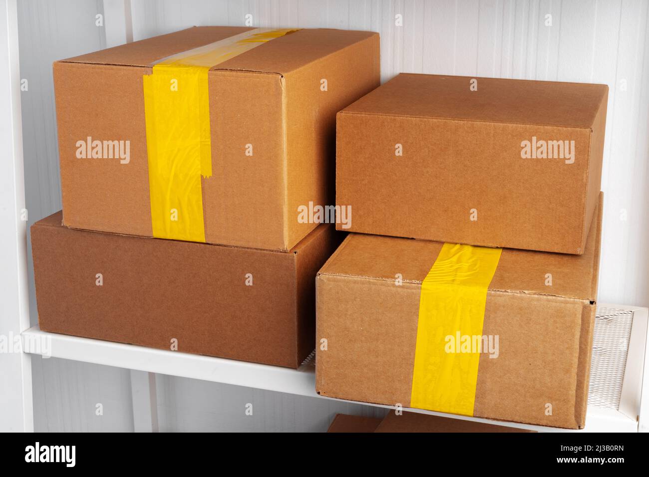 Stack of cardboard package boxes on wooden rack Stock Photo - Alamy