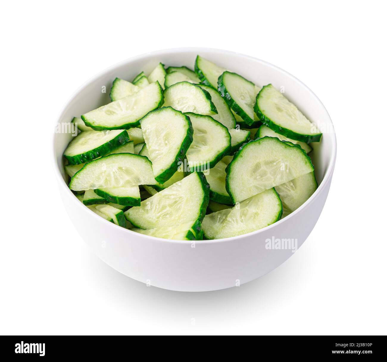 Cucumbers cut into pieces in a bowl, isolated on a white background ...