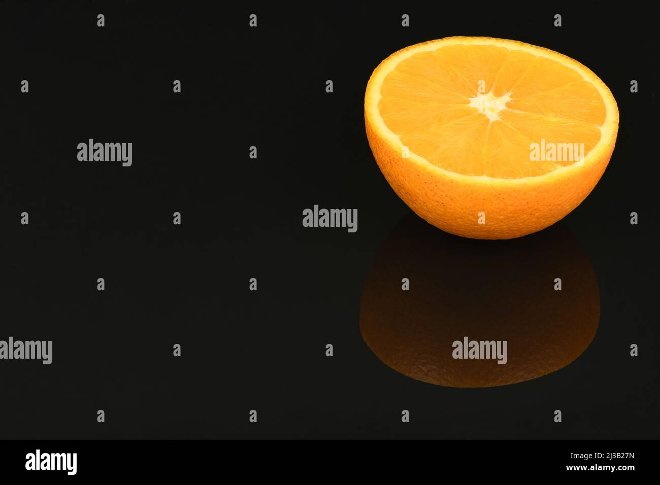 Perfectly retouched orange isolated on acrylic black background. High ...