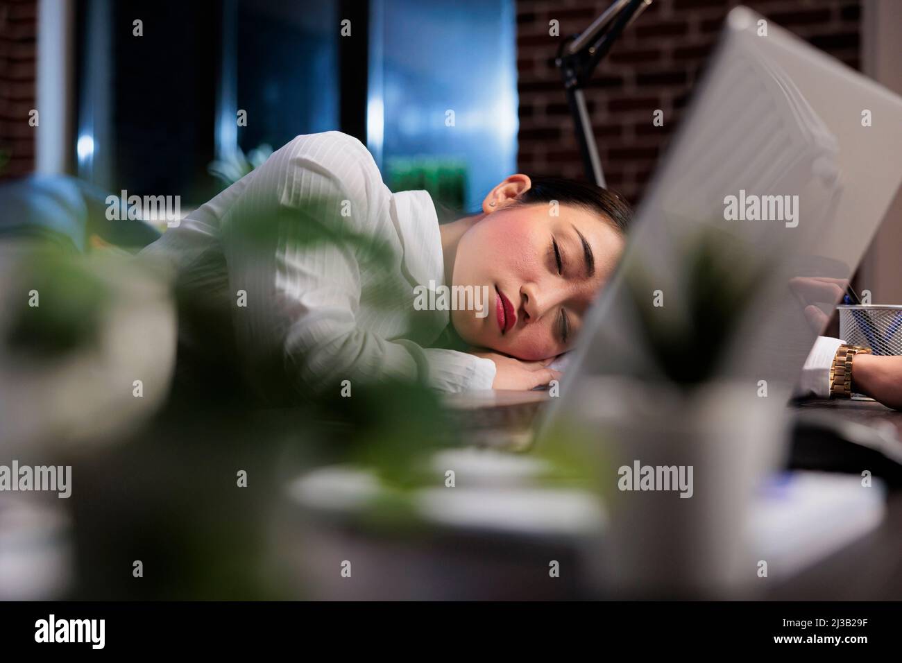 Tired executive manager with burnout syndrome sleeping at work because ...