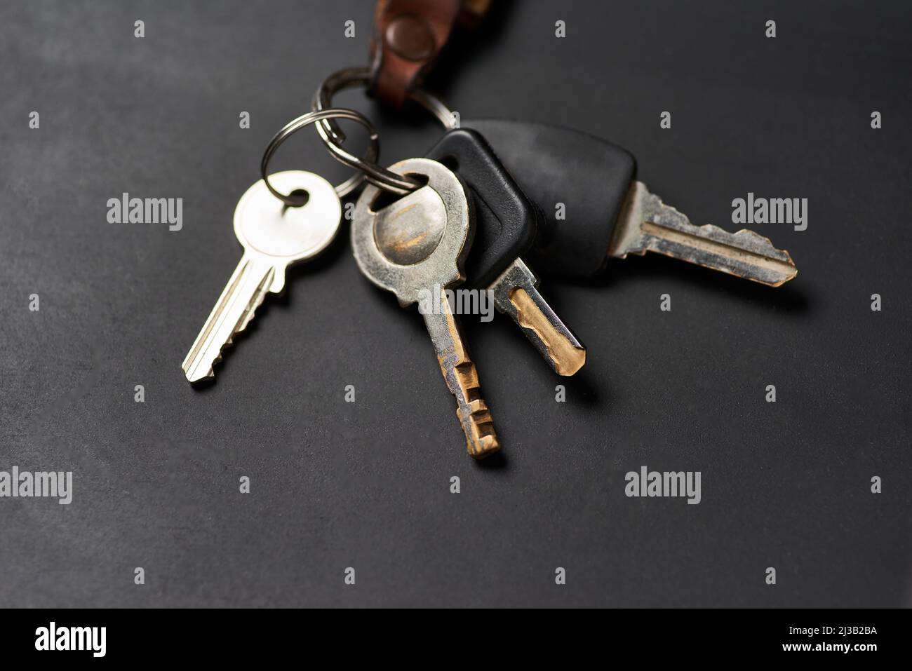 The bunch of keys on the black floor Stock Photo - Alamy