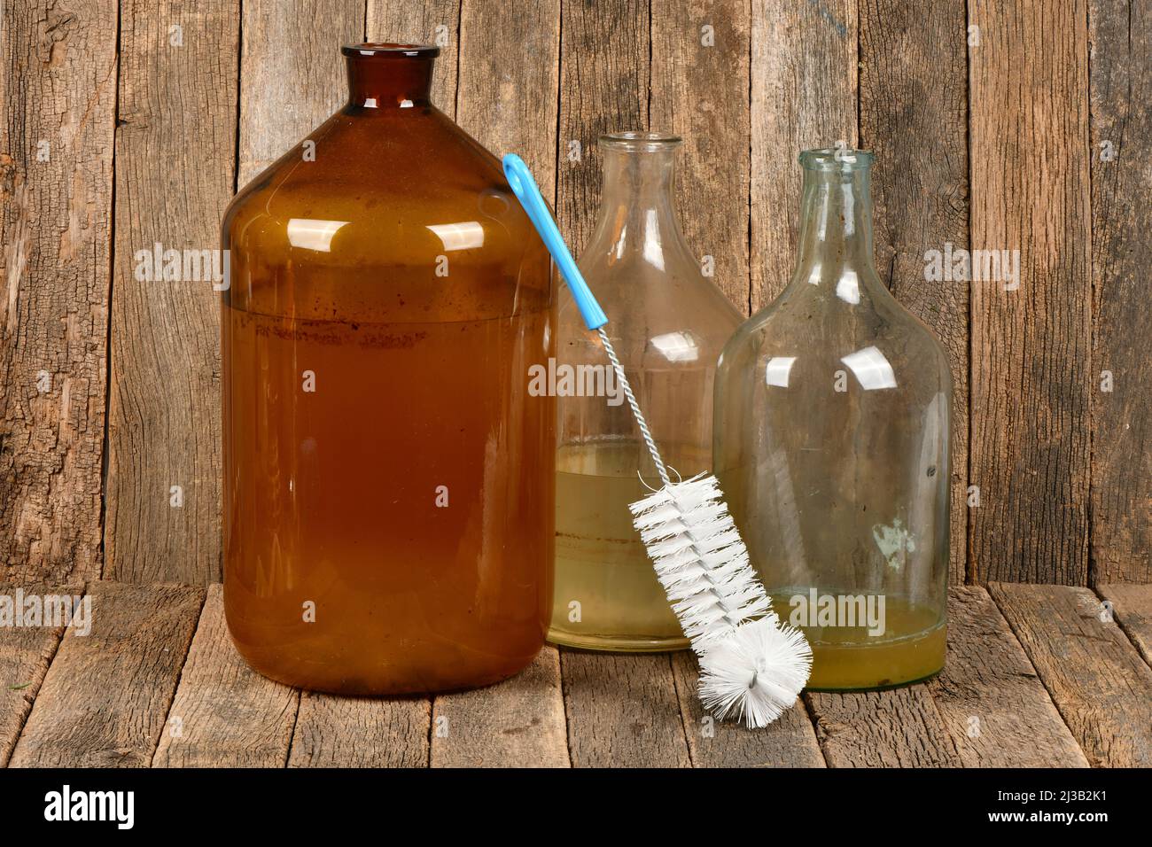 Wire brush for cleaning bottles isolated on dark wood background. High ...