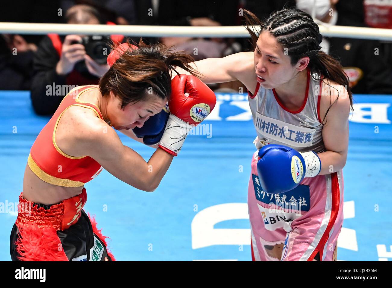 Tokyo, Japan. 25th Feb, 2022. Nanae Suzuki (blue gloves) hits Mika Iwakawa (red gloves) during ...