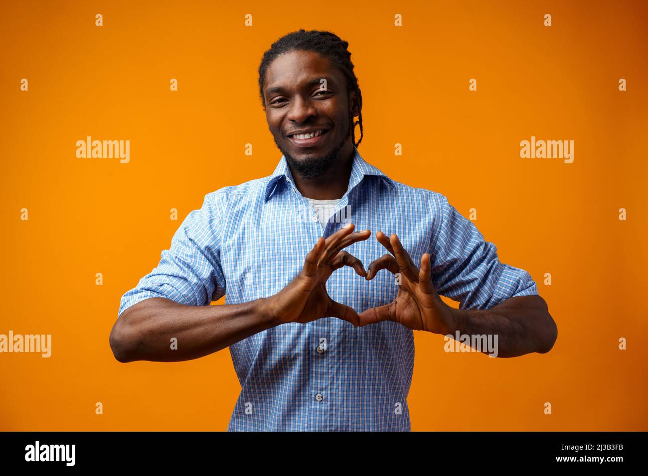 Cheerful black man making heart hi-res stock photography and images - Alamy