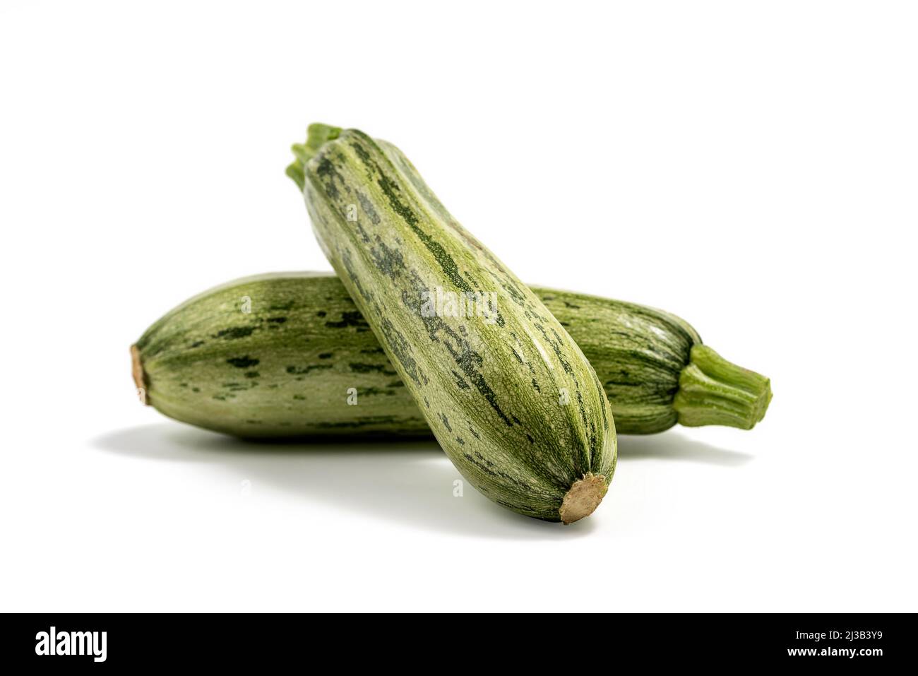 Description: Fresh cut zucchini isolated on a white background with ...
