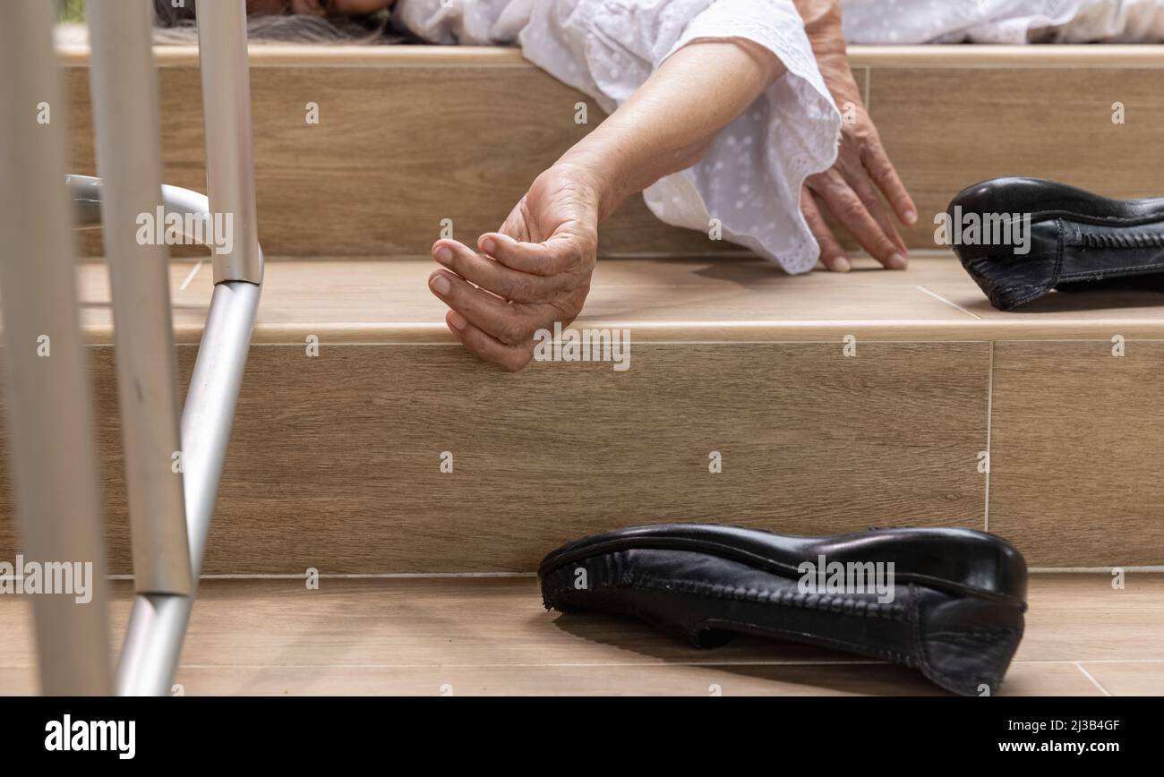 Elderly woman with walker falling down stair Stock Photo - Alamy