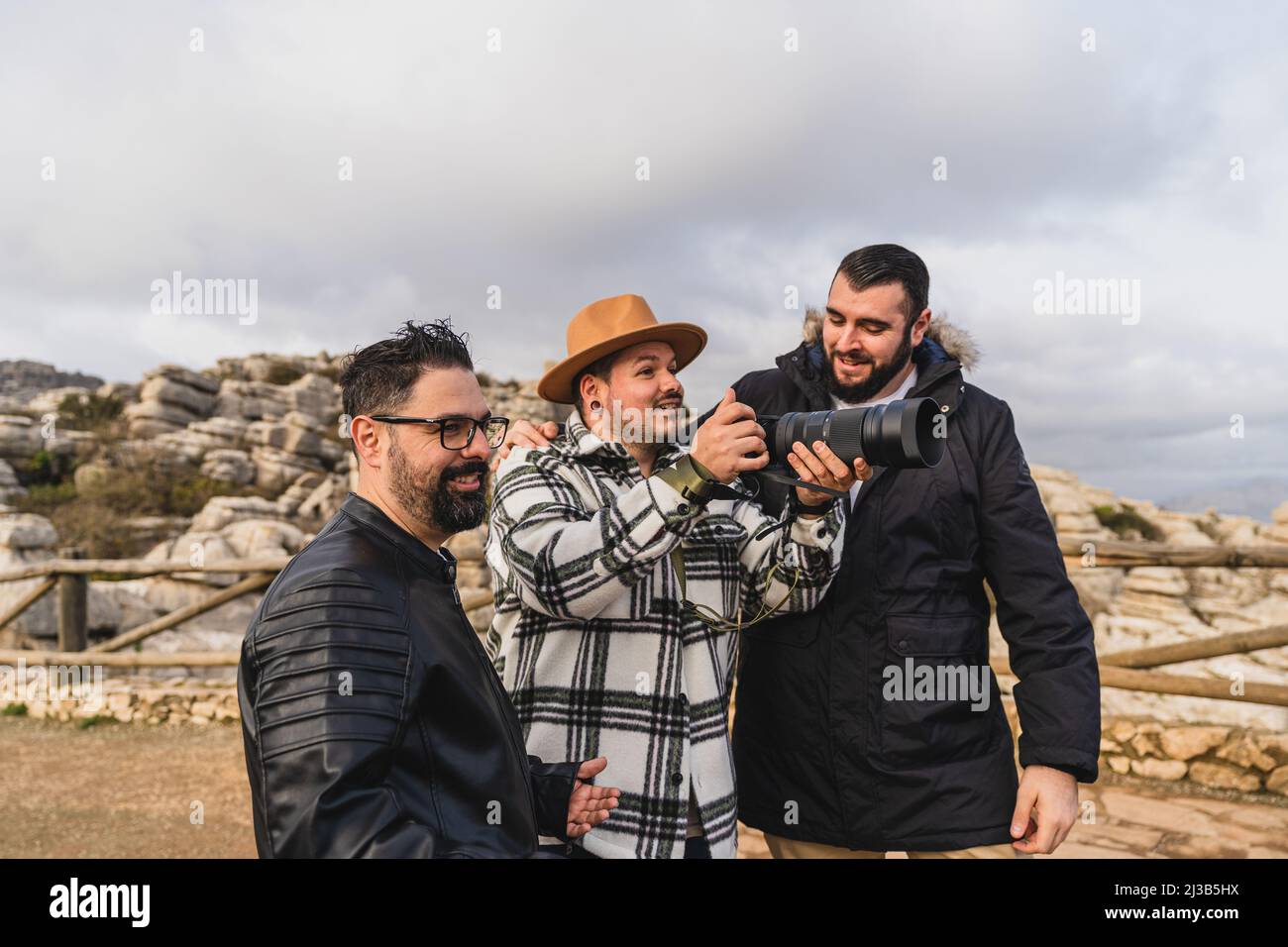A beautiful shot of three Caucasian men standing in El Torcal de ...