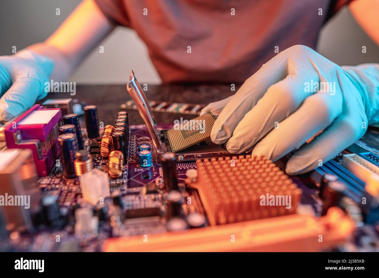 Engineer repairman holding hands in black gloves chip processor, CPU to ...
