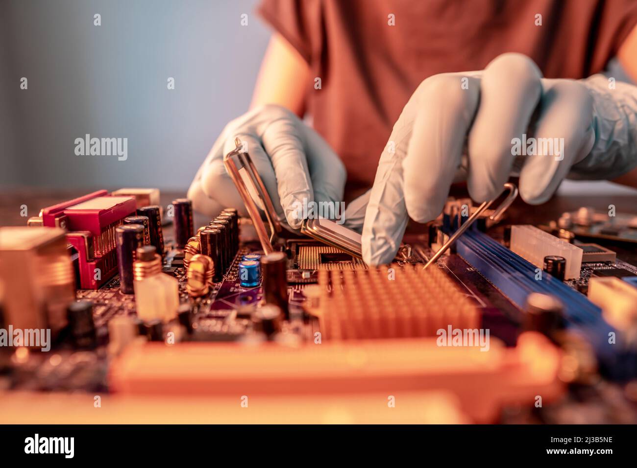Engineer repairman holding hands in black gloves chip processor, CPU to insert into the socket ...