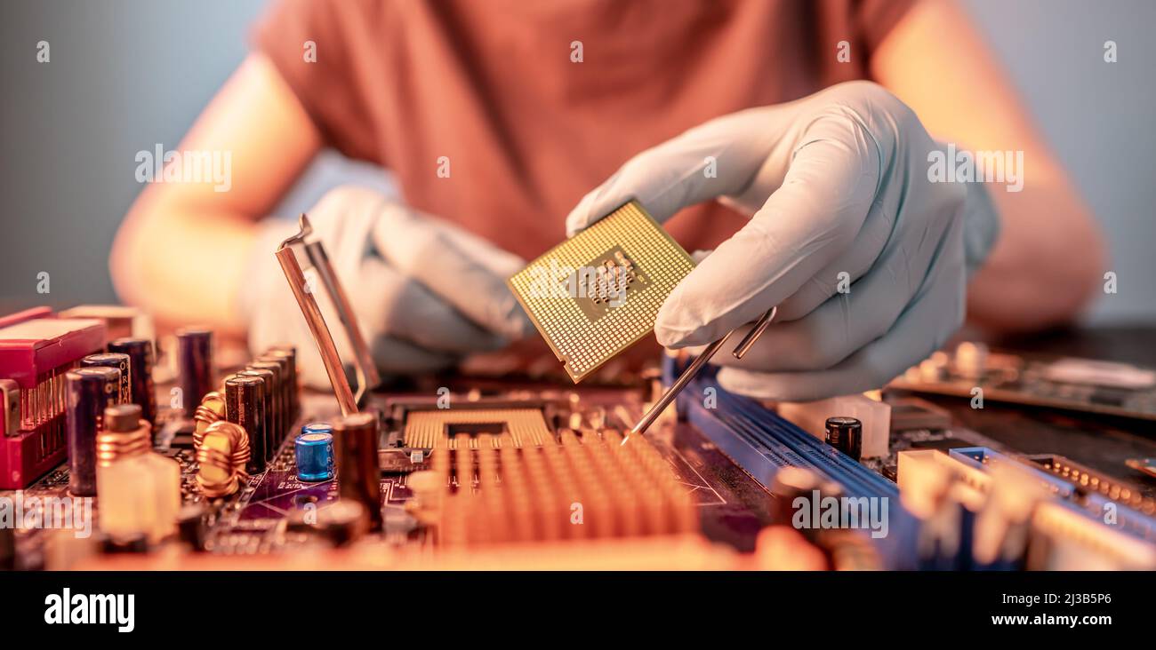 Engineer repairman holding hands in black gloves chip processor, CPU to ...